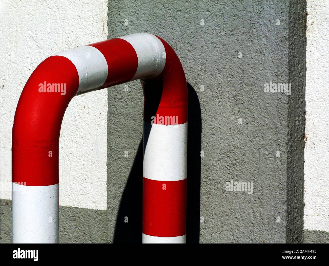red and white painted steel safety barrier rail pipe. bollard with ...