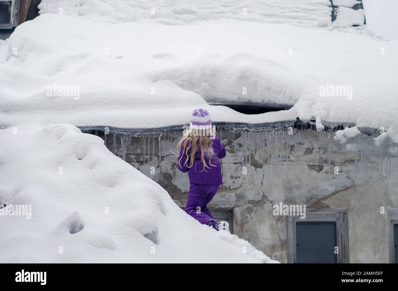 adorable girl with long hair having fun with frozen icicles in snowy ...