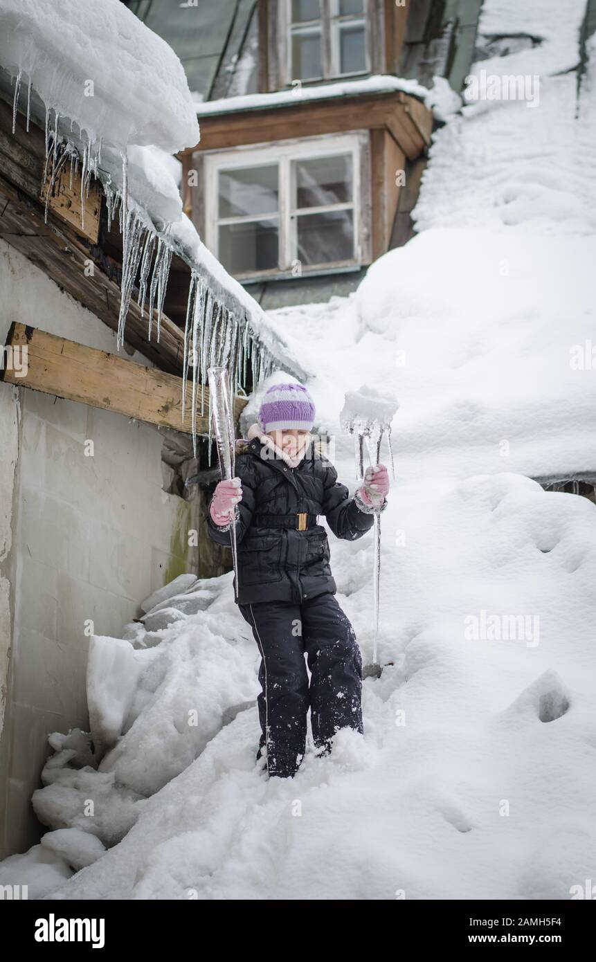 adorable girl having fun with frozen icicles in snowy wonderland Stock ...