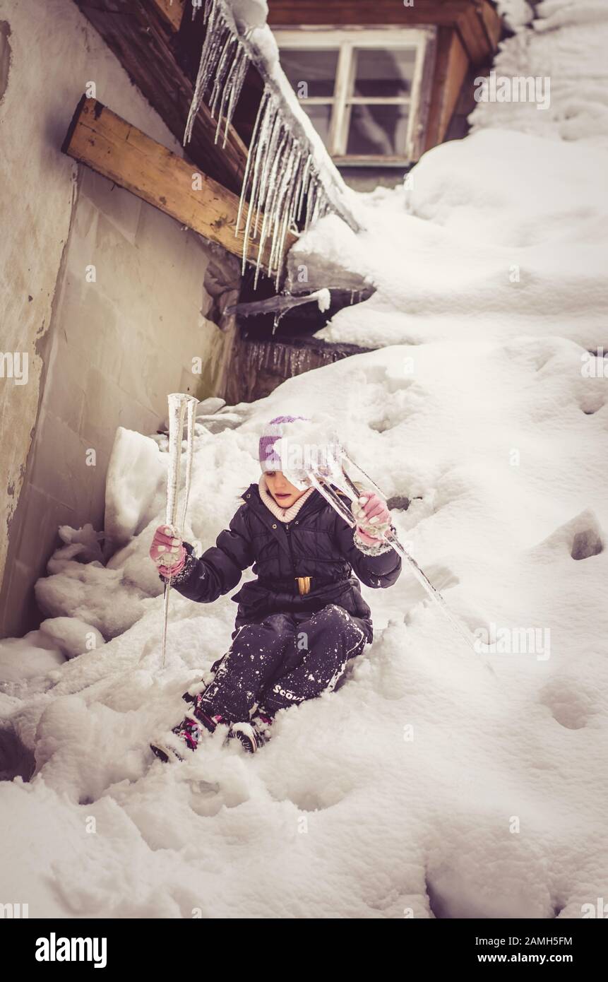 adorable girl having fun with frozen icicles in snowy wonderland Stock ...
