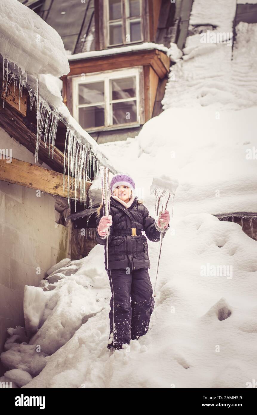 adorable girl having fun with frozen icicles in snowy wonderland Stock ...