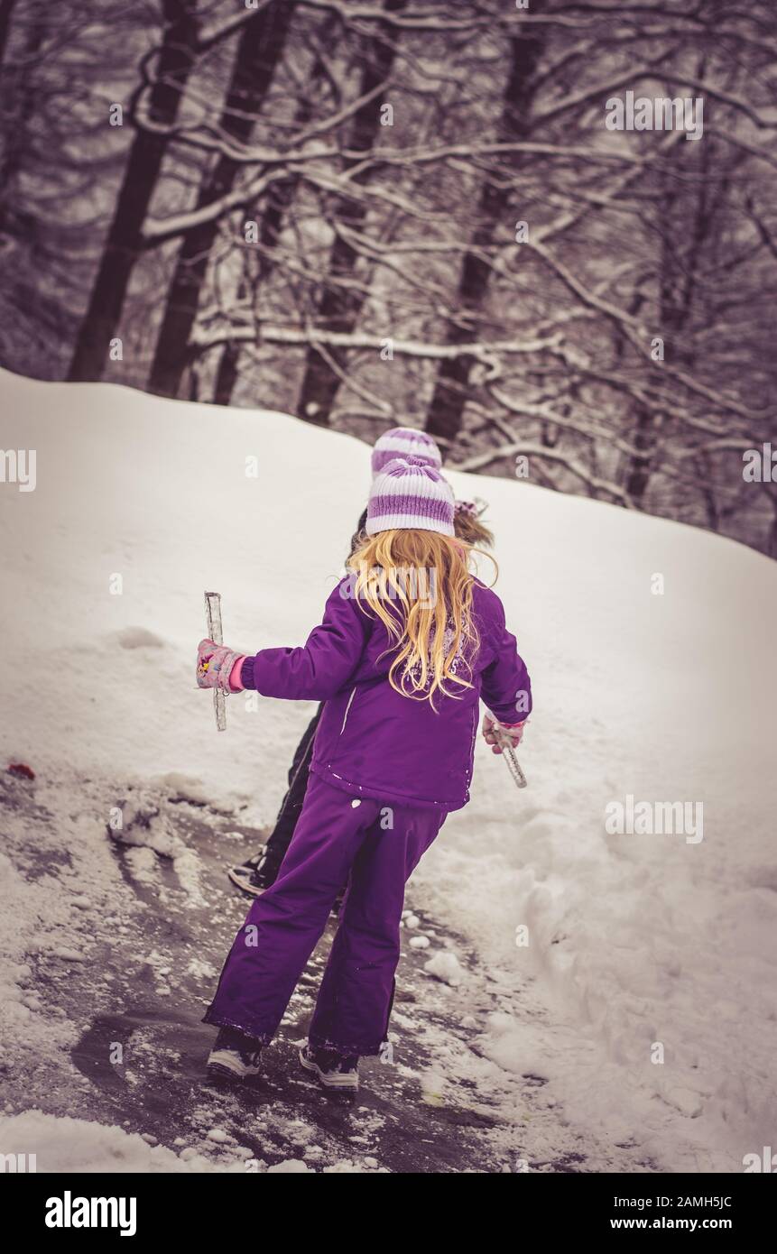 adorable girl having fun with frozen icicles in snowy wonderland Stock ...