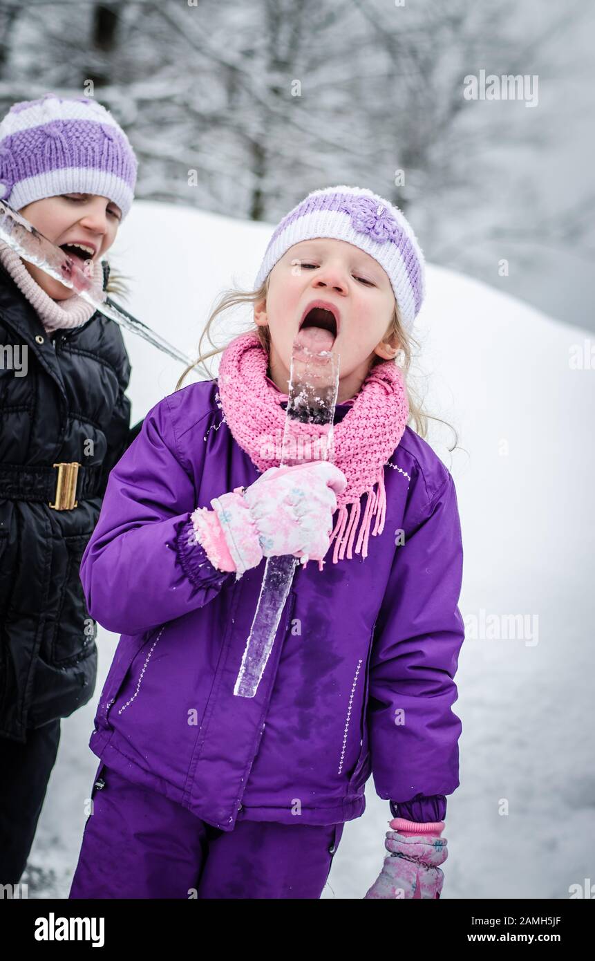 adorable girl having fun with frozen icicles in snowy wonderland Stock ...