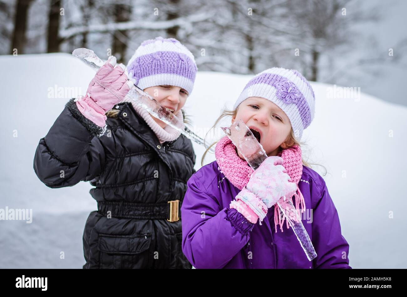 adorable girl having fun with frozen icicles in snowy wonderland Stock ...