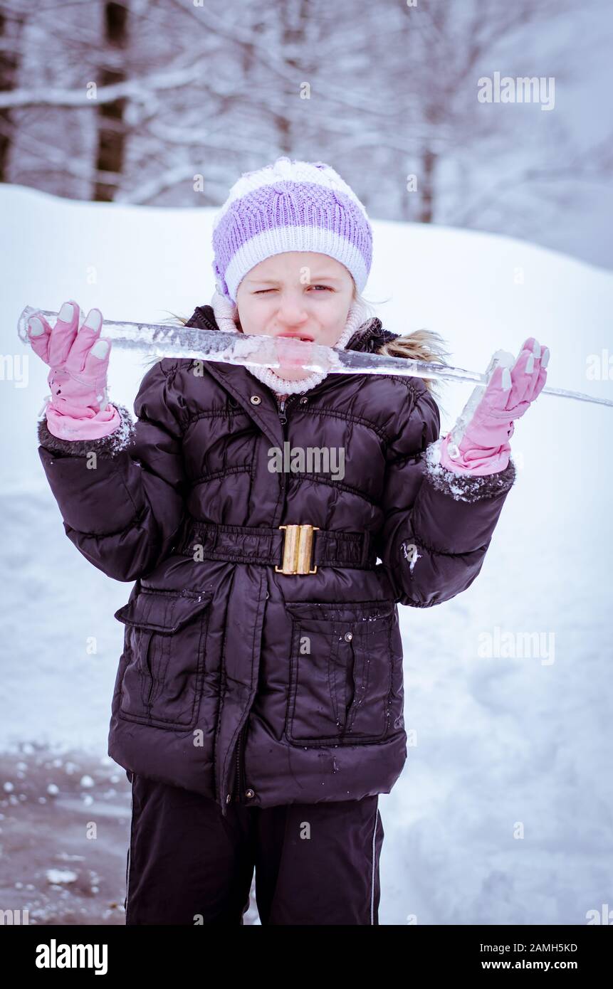 adorable girl having fun with frozen icicles in snowy wonderland Stock ...