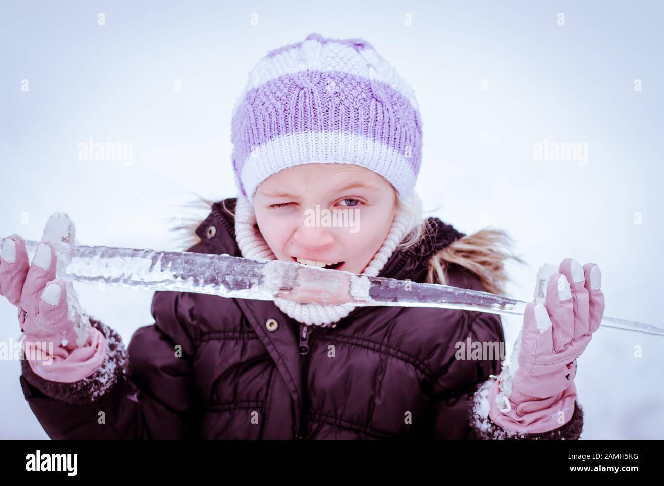 adorable girl having fun with frozen icicles in snowy wonderland Stock ...