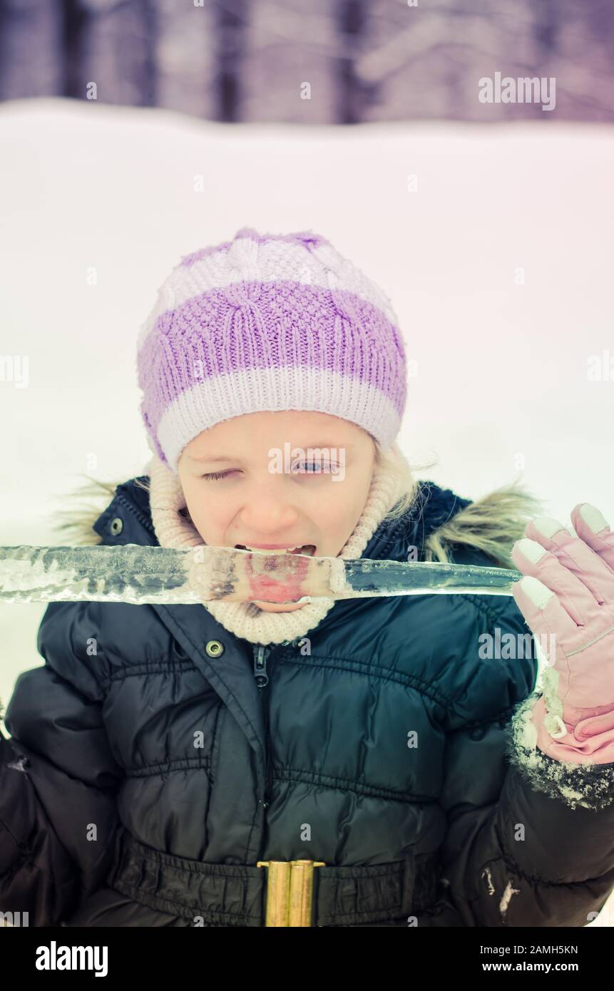 adorable girl having fun with frozen icicles in snowy wonderland Stock ...