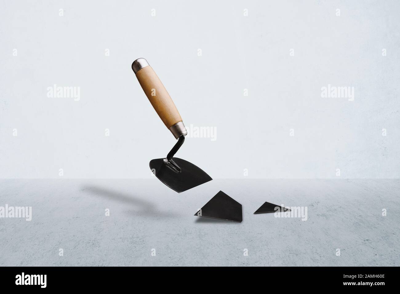 broken construction spatula over concrete room background Stock Photo ...