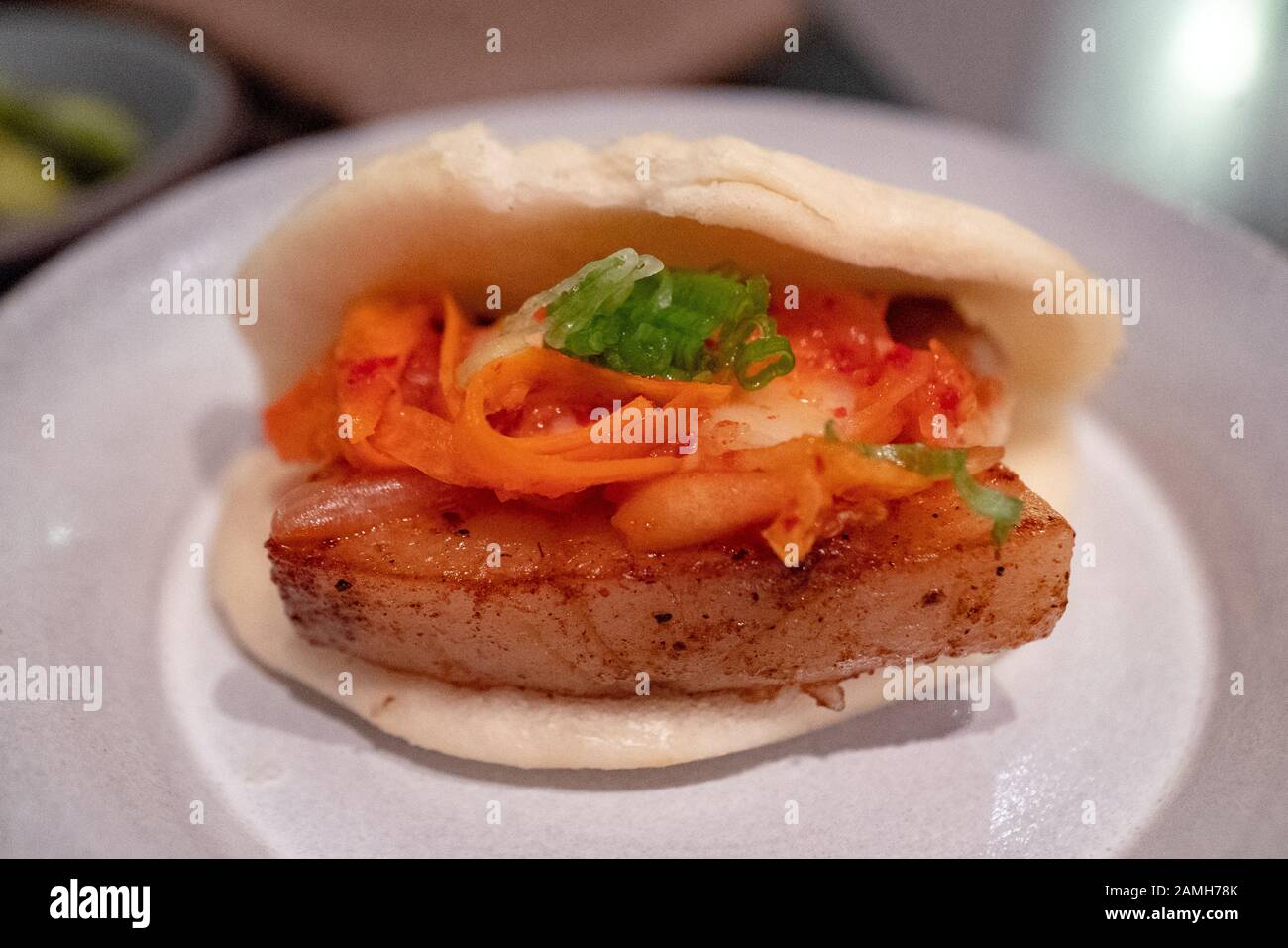Pork belly bun during grand opening event at Bamboo Sushi, an ...