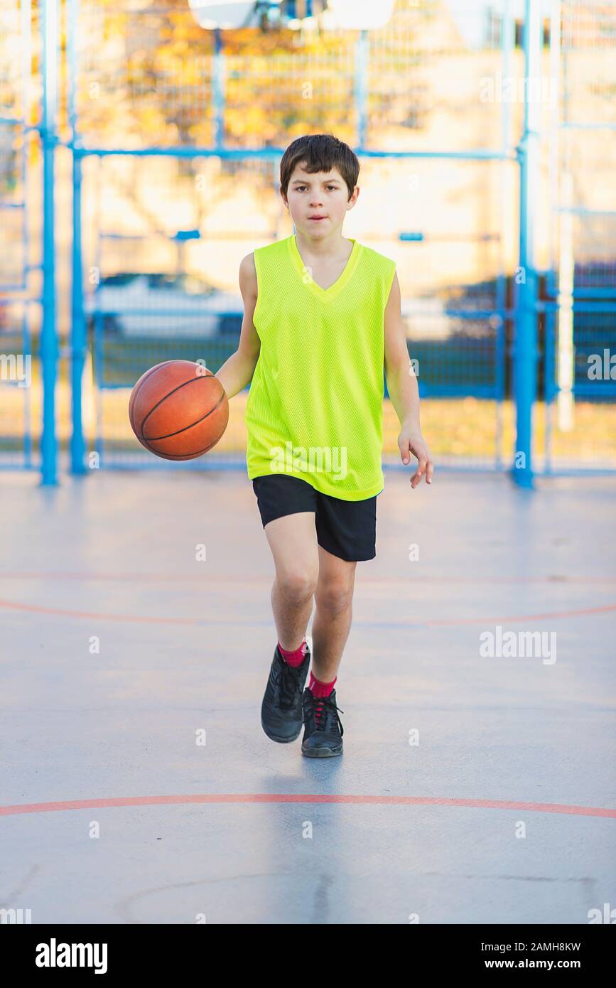 Teenage playing basketball on an outdoors court Stock Photo - Alamy
