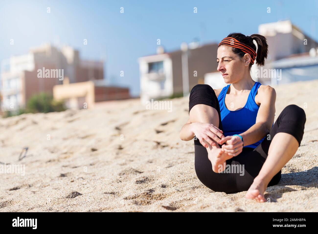 Woman athlete sitting seaside hi-res stock photography and images - Alamy