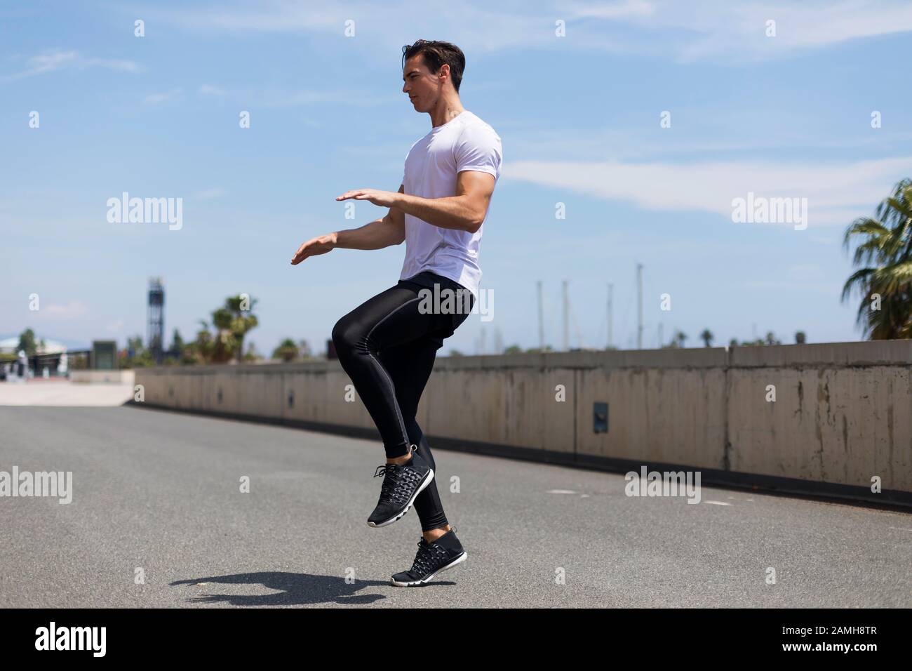 Muscular man doing jumps outdoors Stock Photo - Alamy