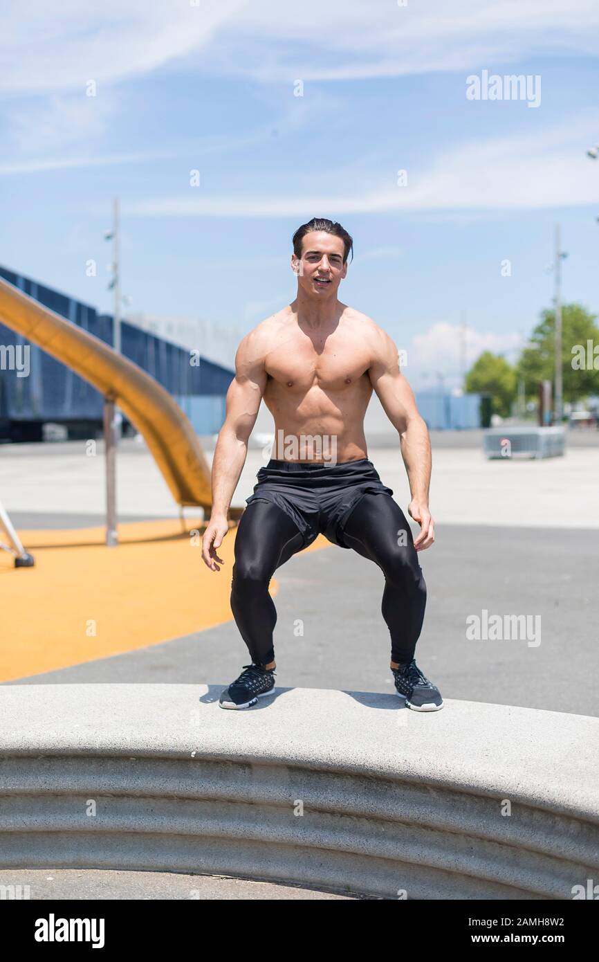 Muscular man doing box jumps outdoors Stock Photo - Alamy