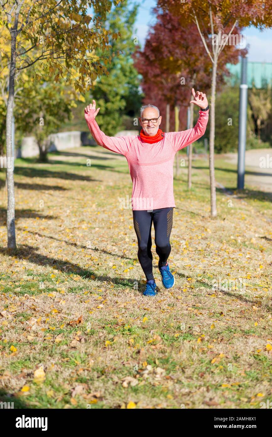 Senior runner man arms up after running Stock Photo - Alamy