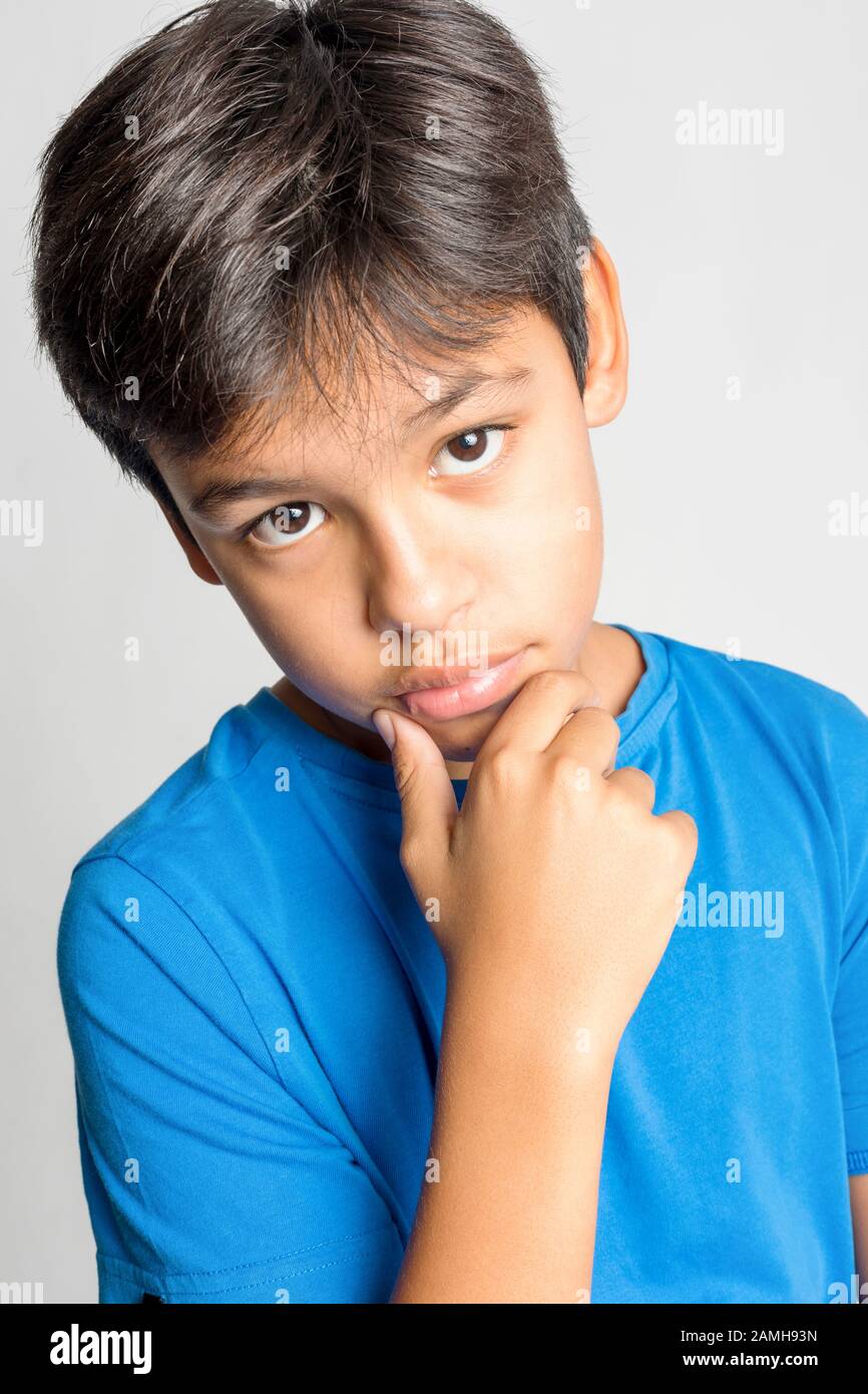 cute boy thinking isolated on white background. Closeup shot of boy ...