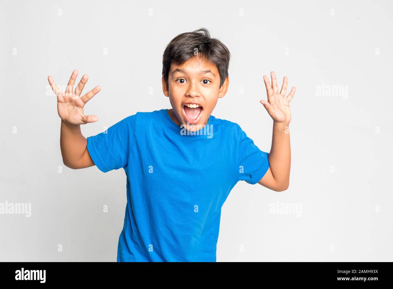 Happy young man with arms up and shouting isolated on a white ...