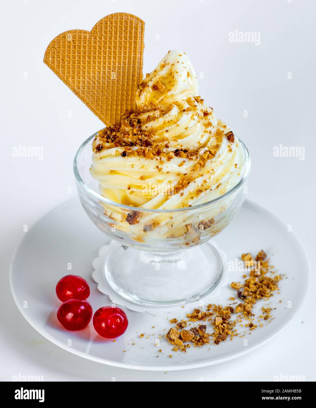 on a white base there is a sundae with vanilla ice cream and sauce and ...