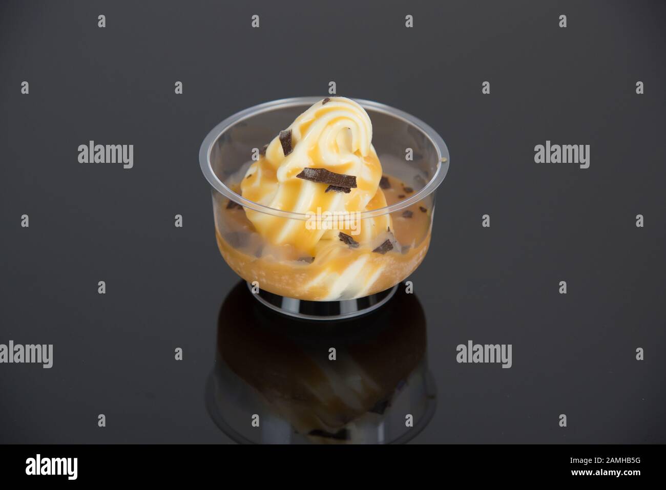 a sundae with vanilla ice cream and sauce on a dark base Stock Photo ...
