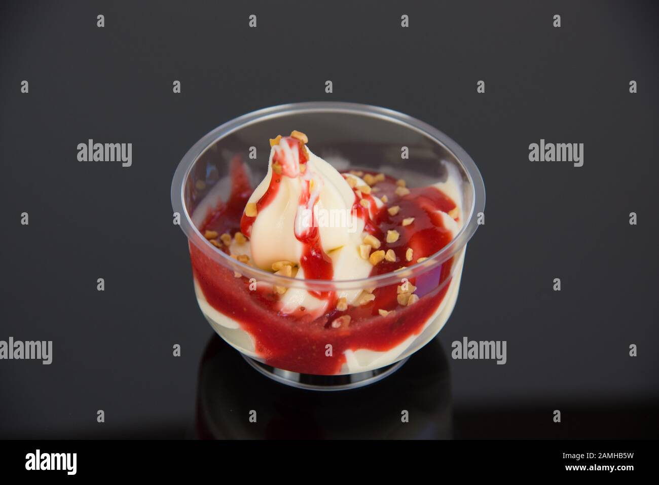 a sundae with vanilla ice cream and sauce on a dark base Stock Photo ...