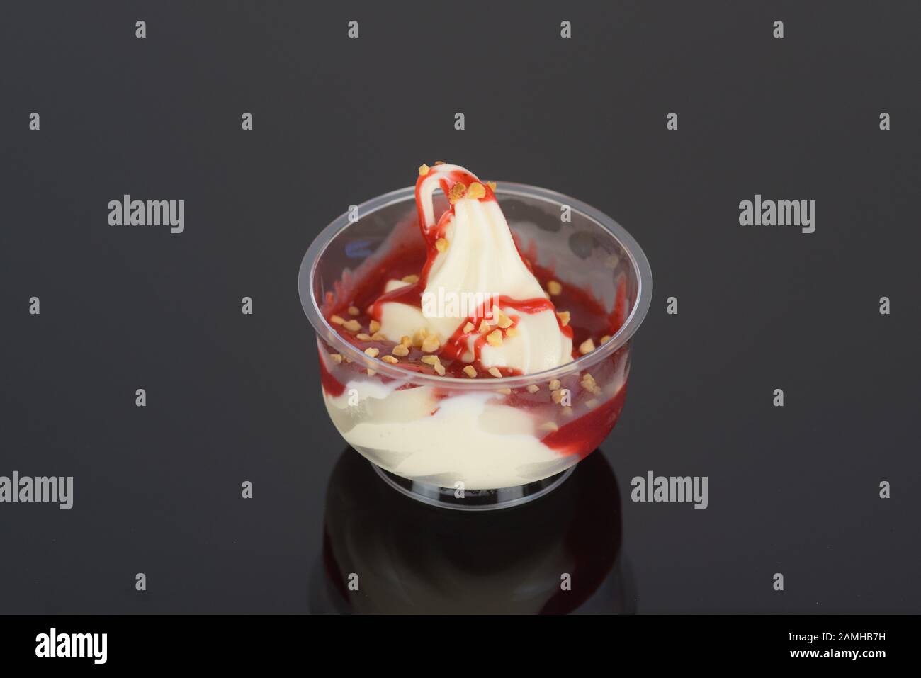 a sundae with vanilla ice cream and sauce on a dark base Stock Photo ...