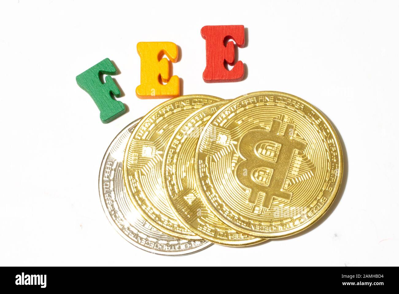 Bitcoin transaction fee concept. Cryptocurrency coins on white ...