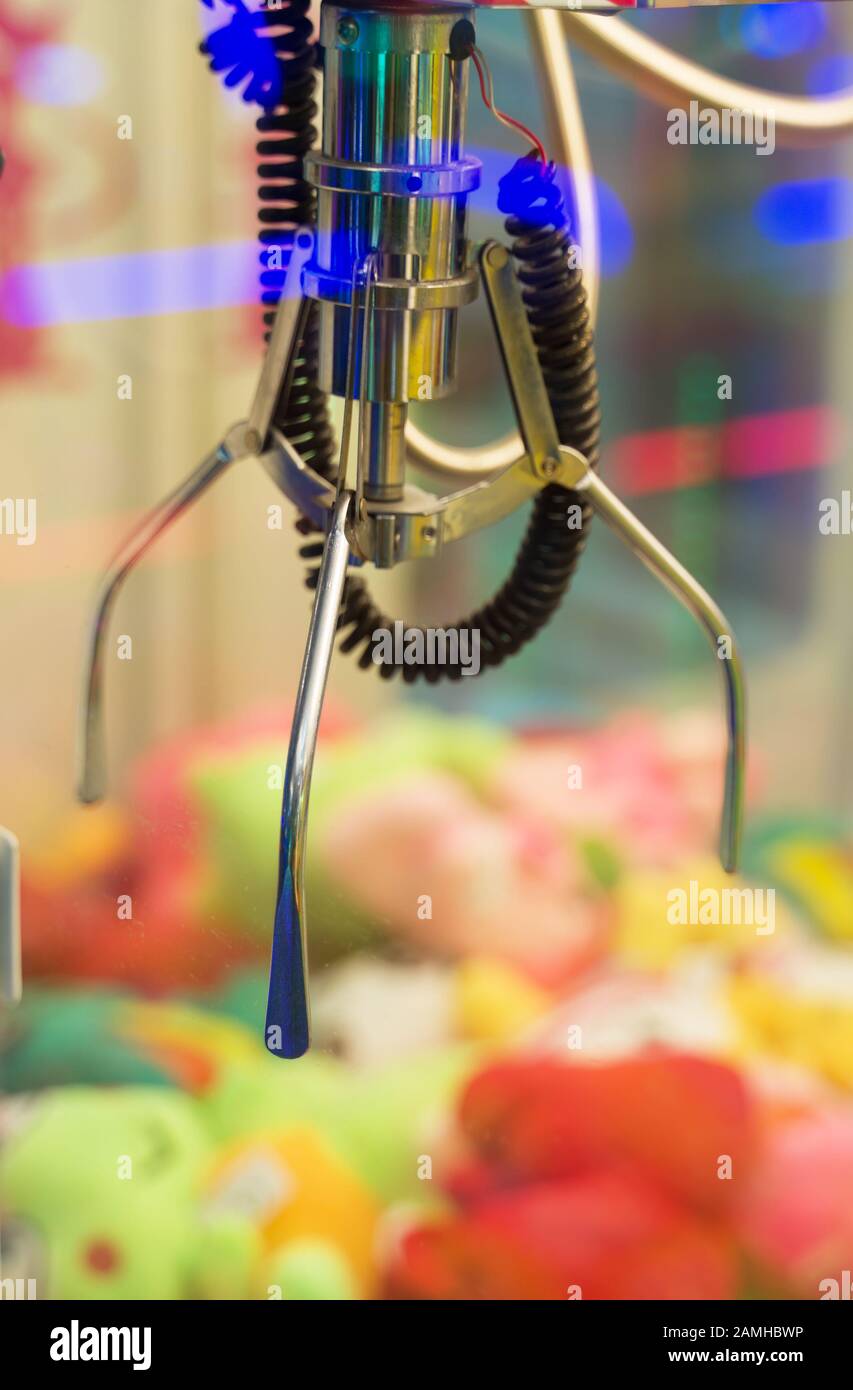 Mechanical claw game machine. Close-up view Stock Photo - Alamy