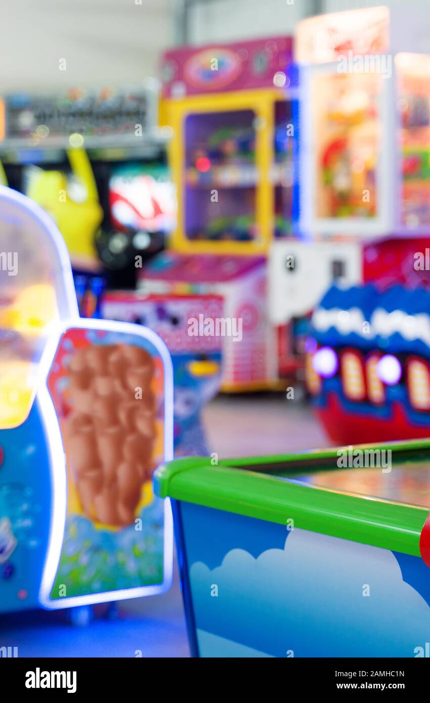 Many arcade machines in amusement park. Blurred photo Stock Photo - Alamy