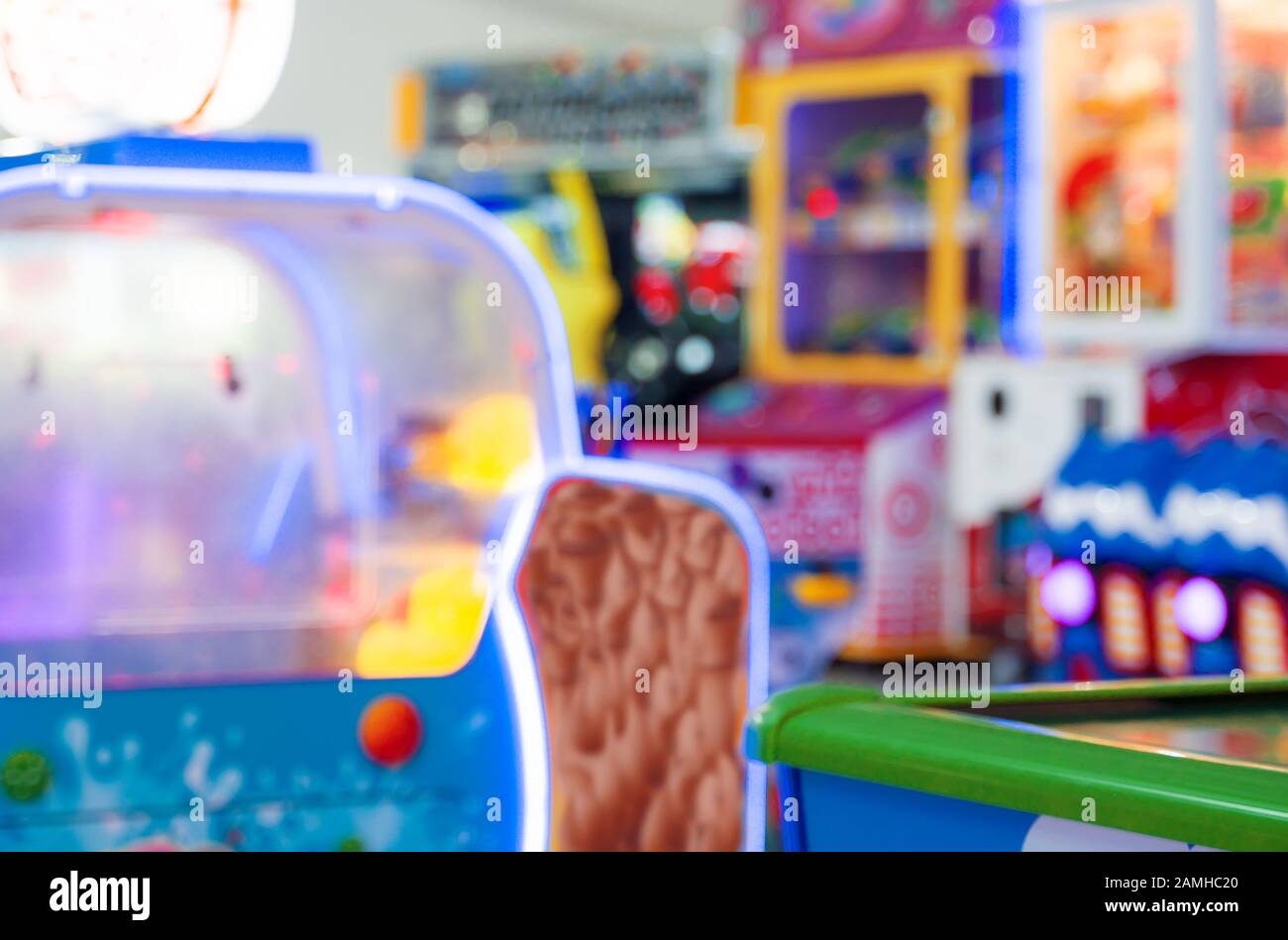 Many arcade machines in amusement park. Blurred photo Stock Photo - Alamy