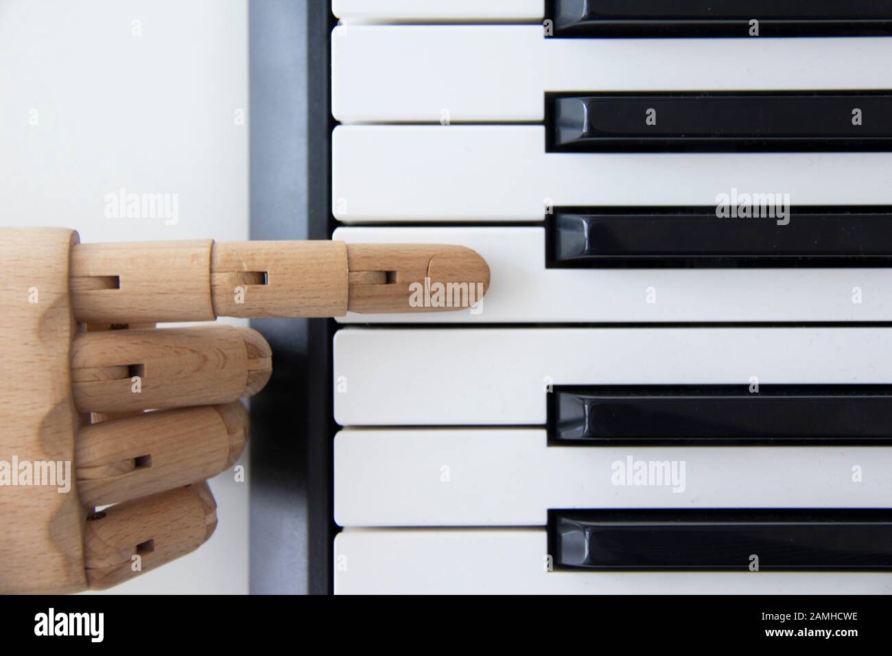 overhead view of a wooden hand playing a electronic keyboard Stock ...
