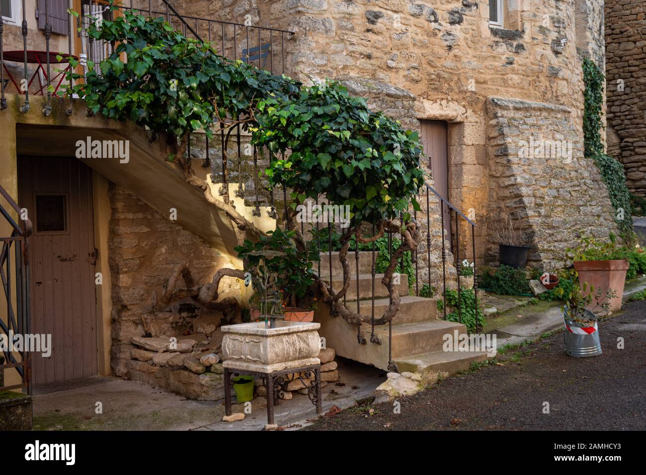 Street scene Goult ,provence , France. ivy growing up stair rail to ...