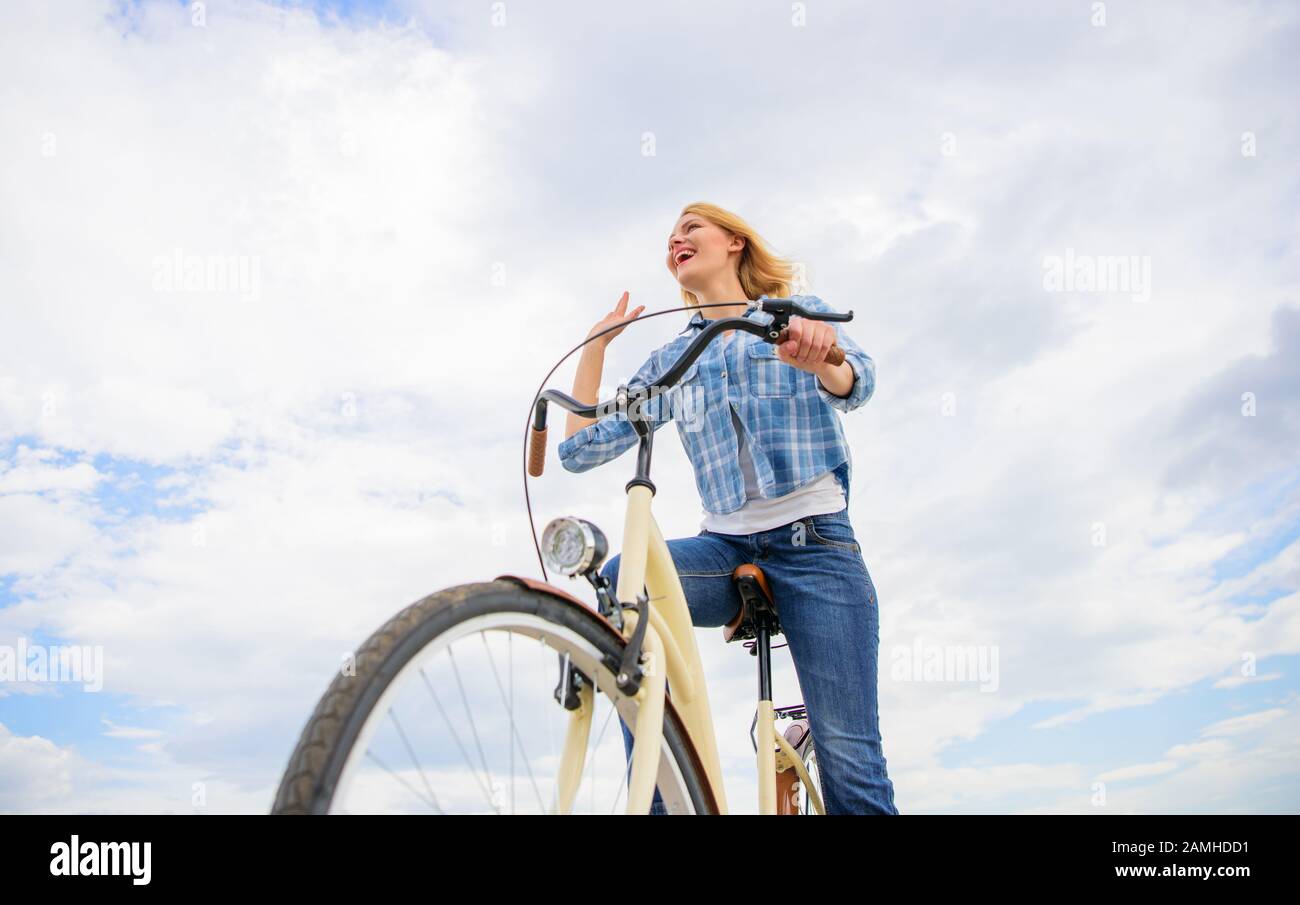 Girl rides bike sky background. Emotional woman enjoy biking holidays ...