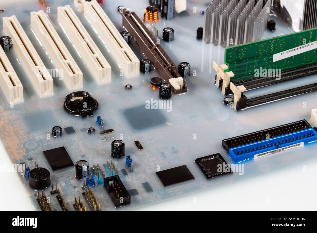 Mainboard card computer flooded by white colored water Stock Photo - Alamy