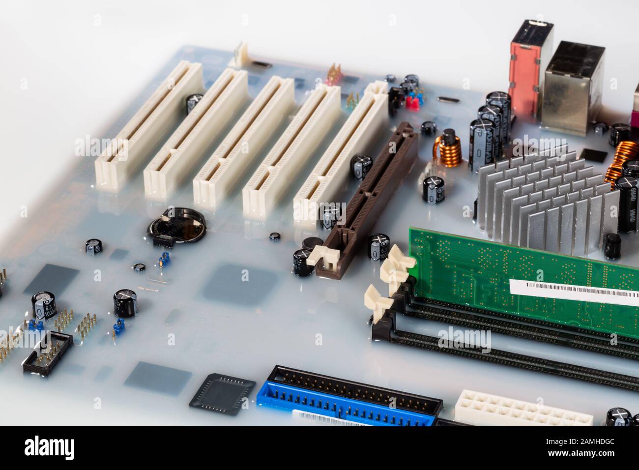 Mainboard card computer flooded by white colored water Stock Photo - Alamy