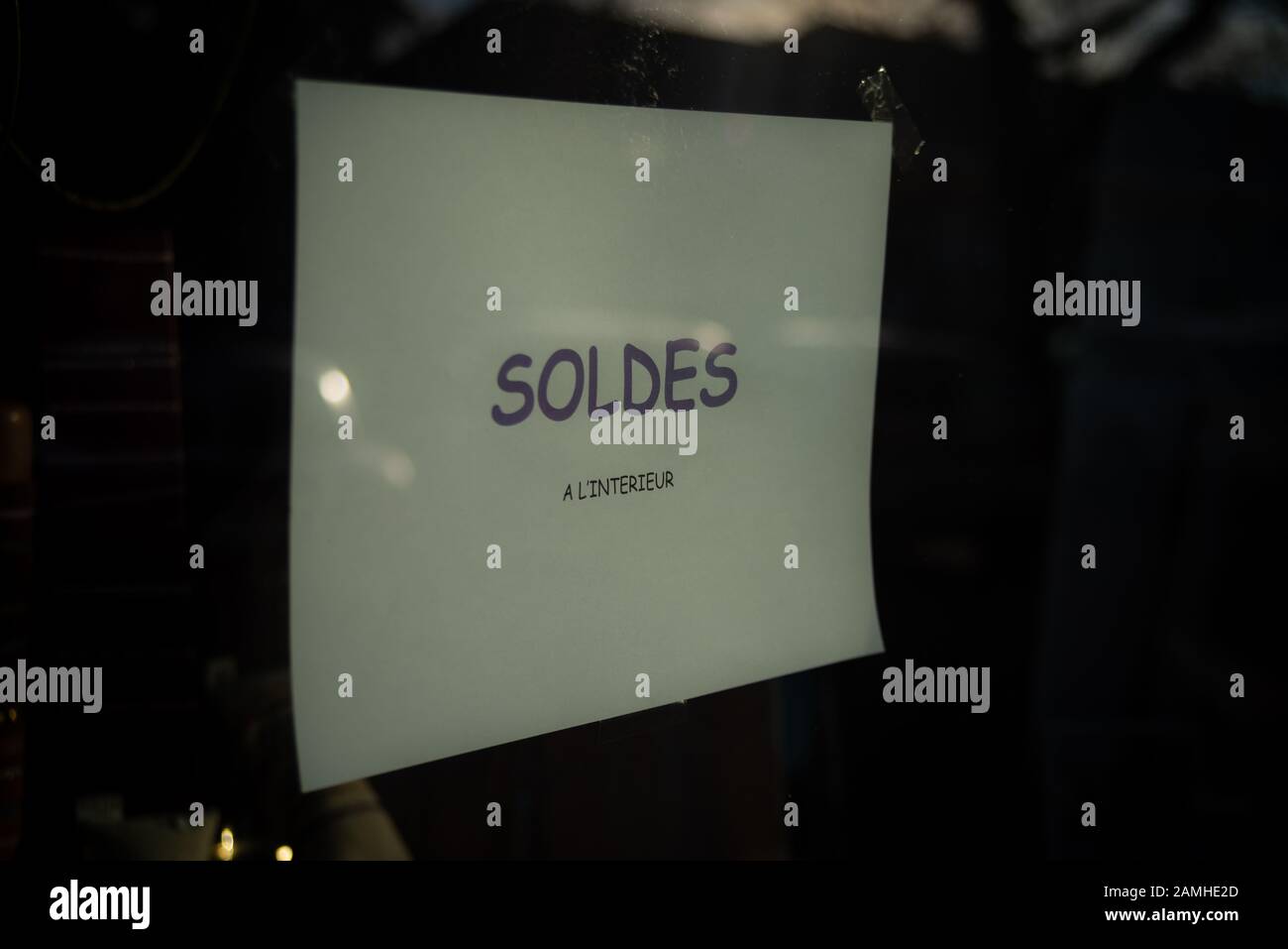 sale sign ,sale inside (translation) in dark French shop window. south ...