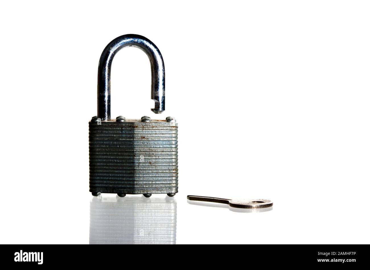 Unlocked old padlock with the key beside it - studio shot on white ...