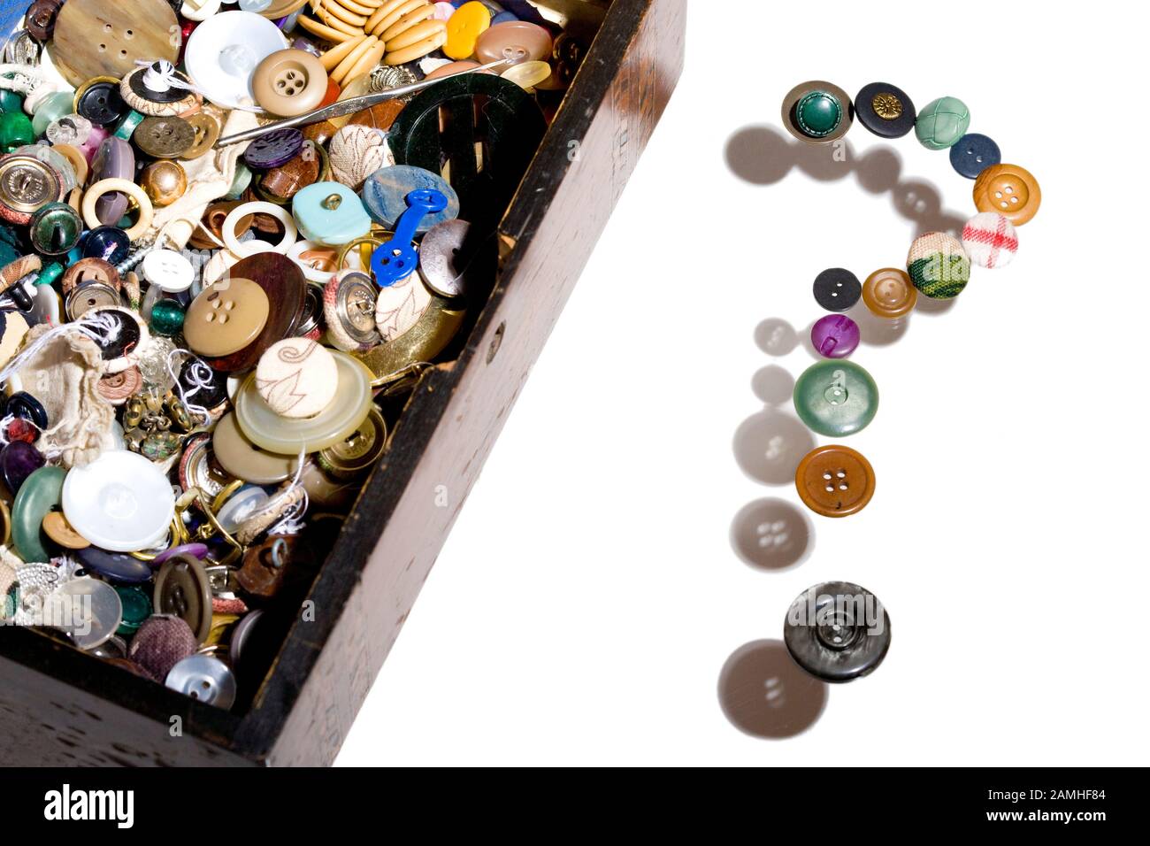 Variety of buttons in a box with question mark made out of buttons ...