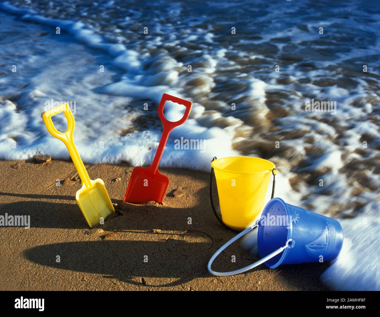 Children's beach spades and buckets beside the sea Stock Photo - Alamy