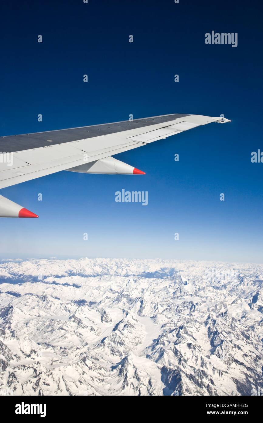 Aircraft flying over the Alps in Winter Stock Photo - Alamy