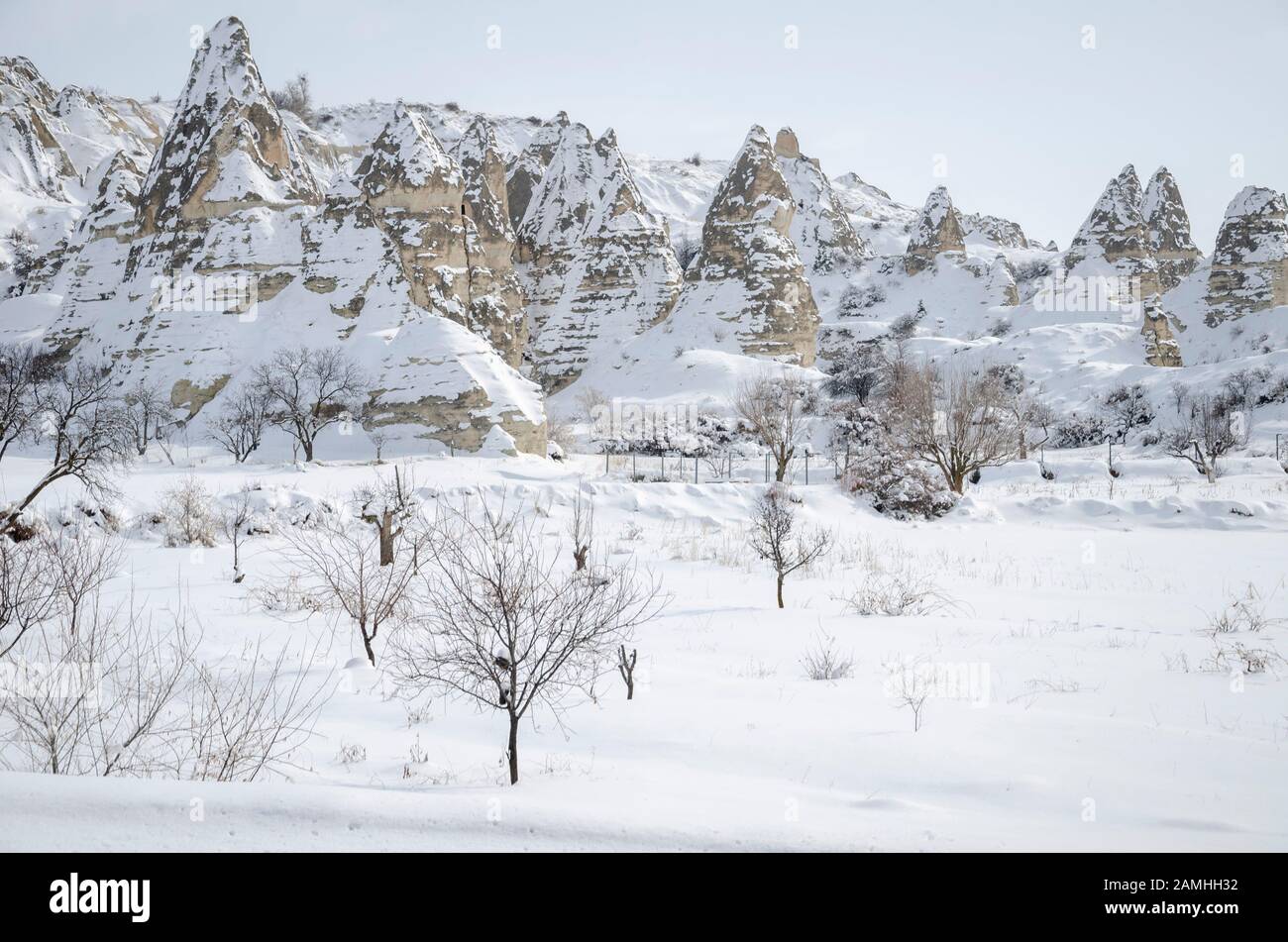 Panorama of unique geological rock formations under snow in Cappadocia ...