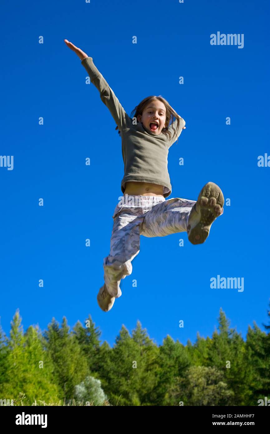 Child full of energy jumping for joy Stock Photo - Alamy