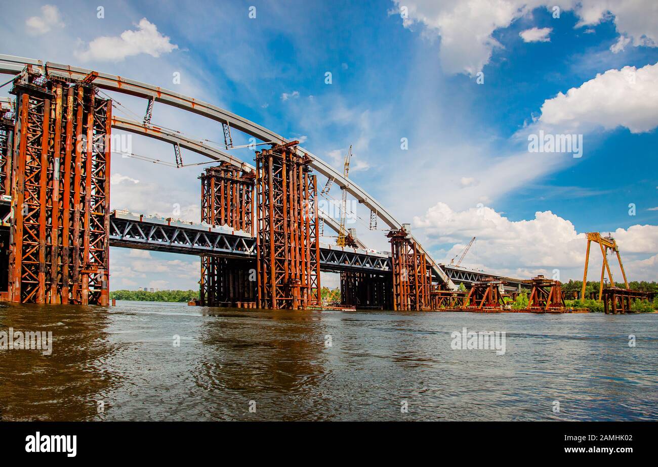 View from the river on a rusty bridge on a clear sunny day. Rusty ...