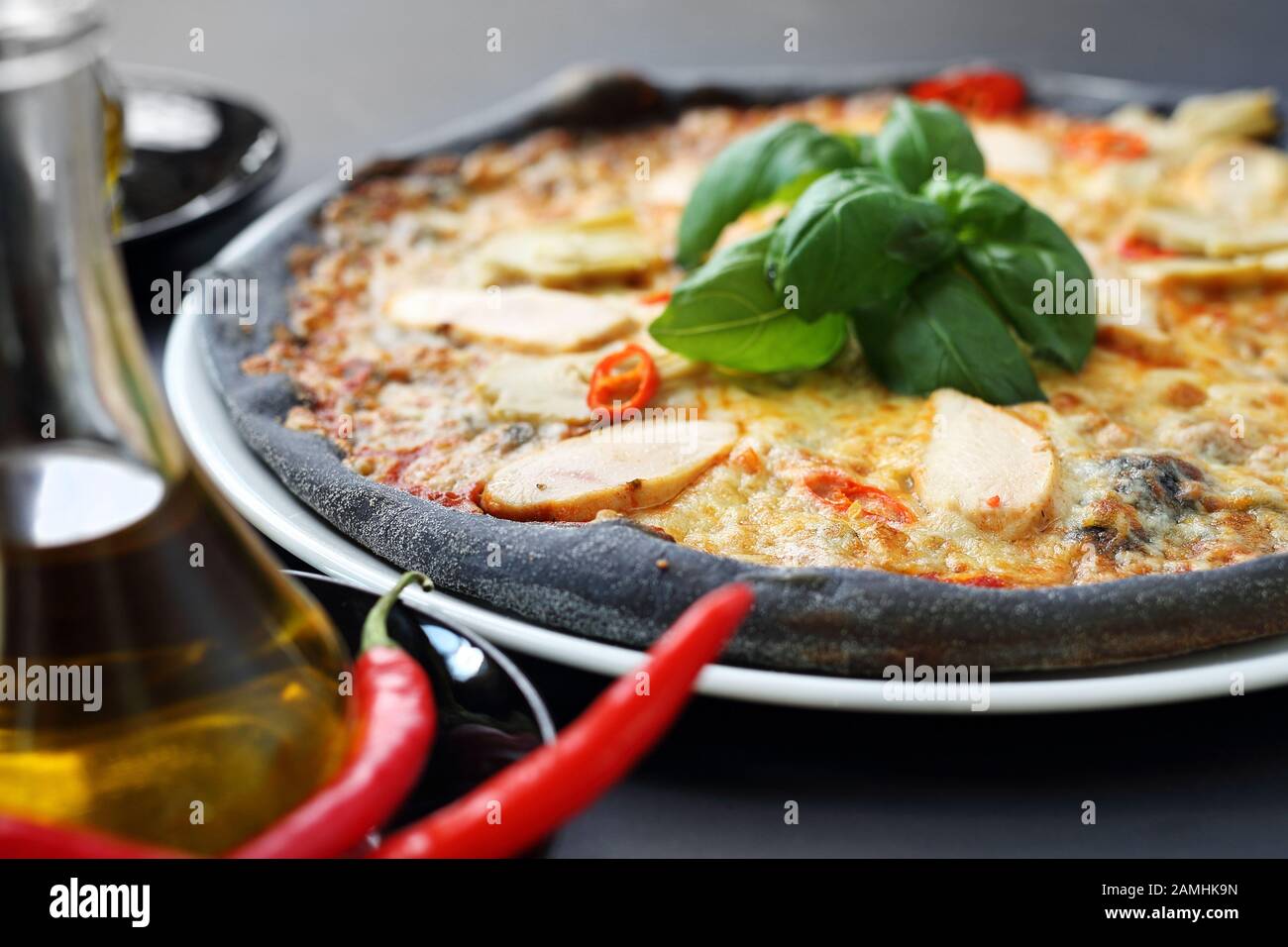 Pizza on black dough. Black pizza.Black food Stock Photo - Alamy