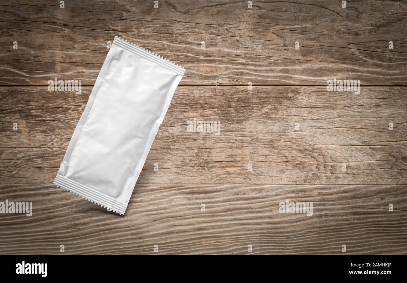 Blank White Condiment Packet Floating on Aged Wood Background Stock ...