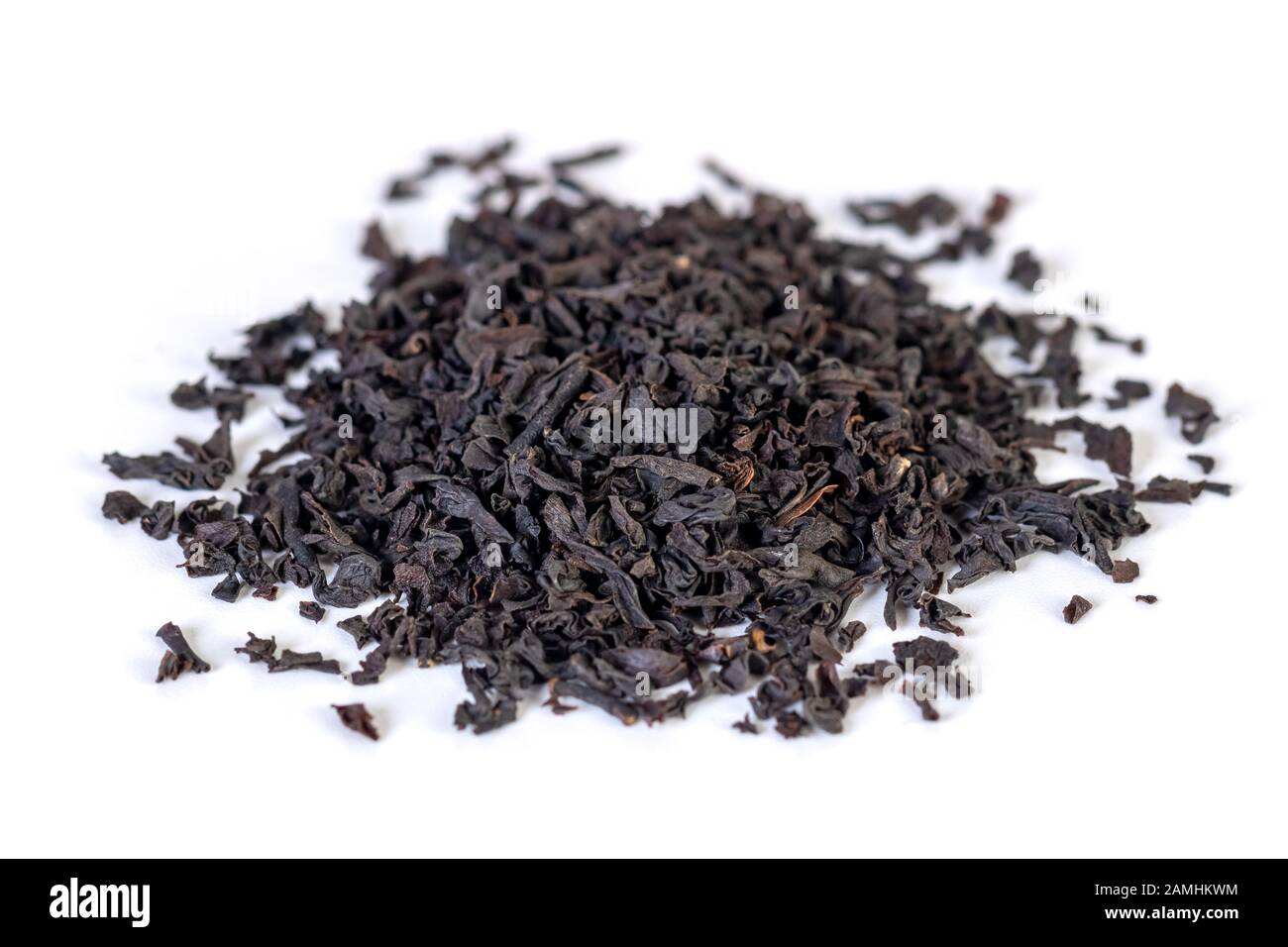 A pile of dried black tea leaves on a white background Stock Photo - Alamy