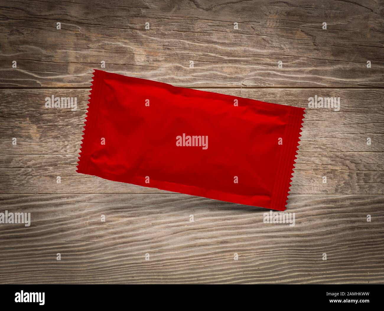Blank Red Condiment Packet Floating on Aged Wood Background Stock Photo ...