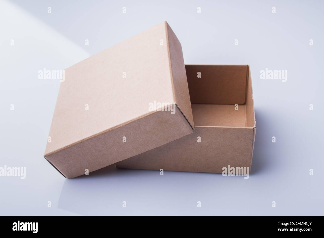 Uncovered small cardboard box Stock Photo - Alamy
