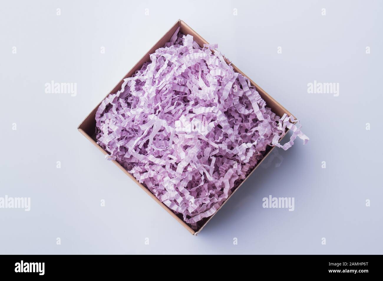 Cardboard box stuffed with purple material Stock Photo - Alamy