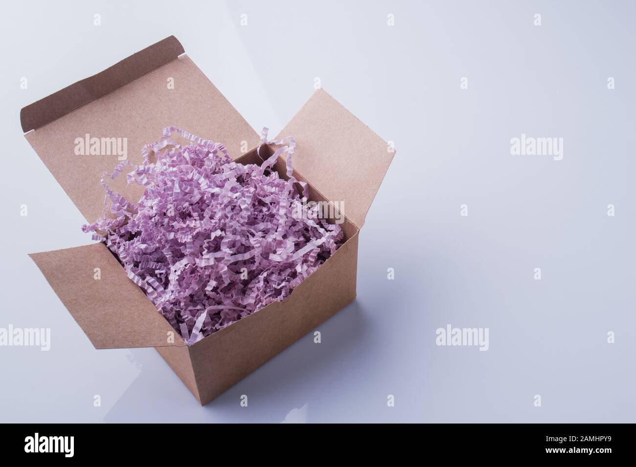Purple pink shredded paper gifting stuffing cardboard box Stock Photo ...