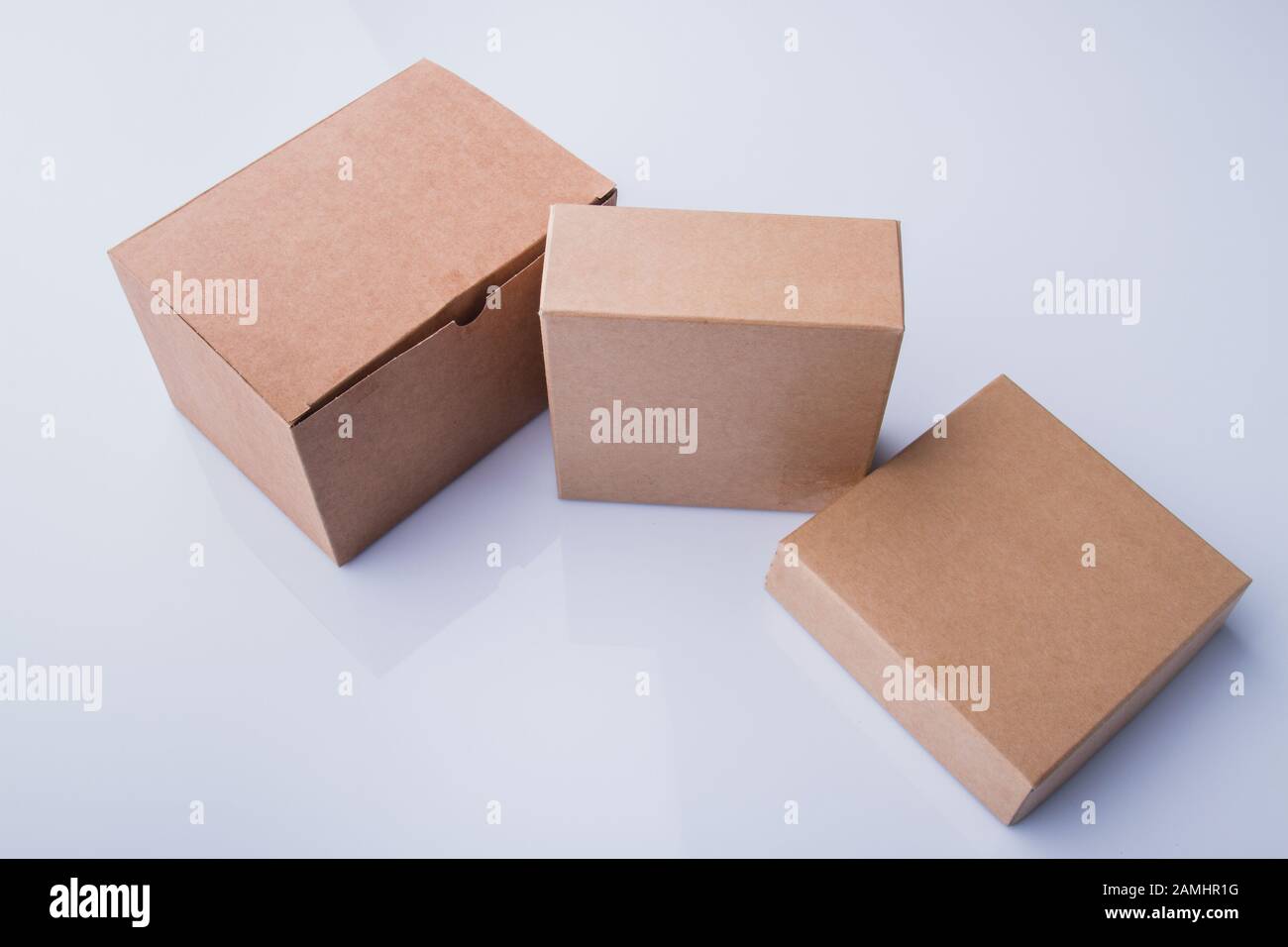 Three different beige cardboard boxes Stock Photo - Alamy