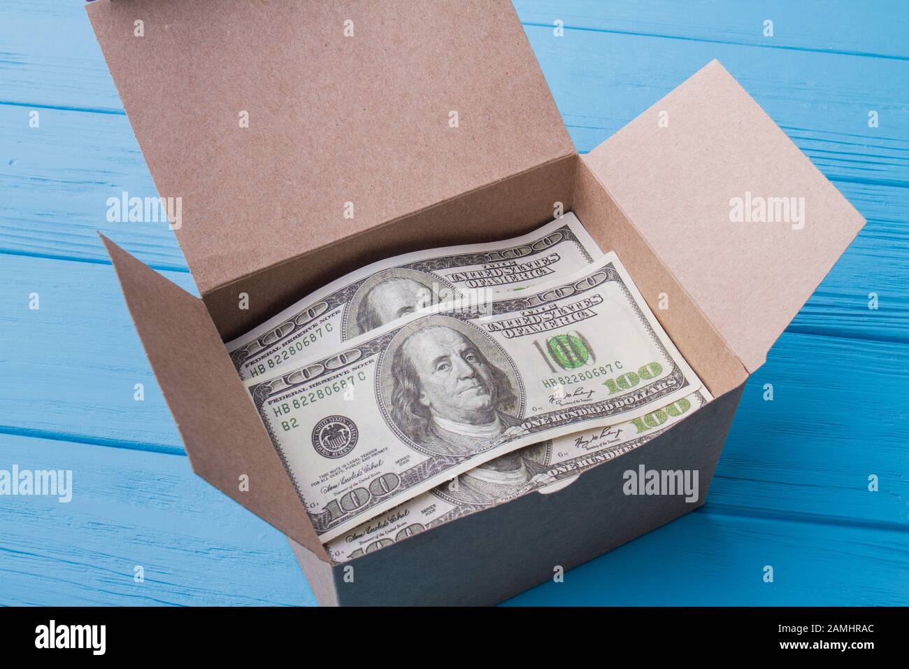 Cardboard mail box with dollars Stock Photo - Alamy